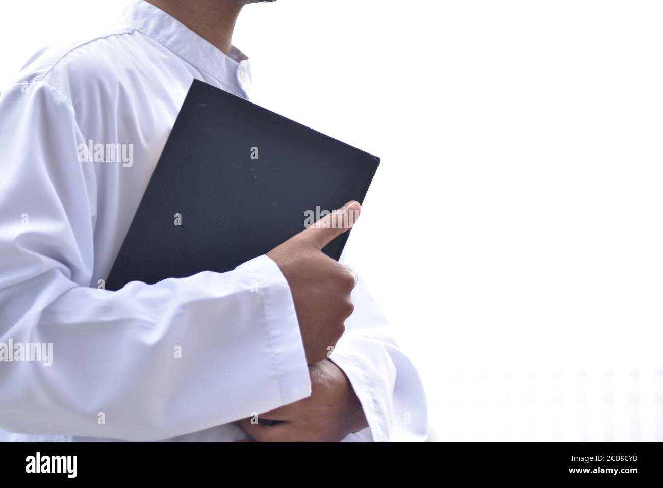 Holy Quran in hand with arabic calligraphy meaning of Al Quran Stock ...
