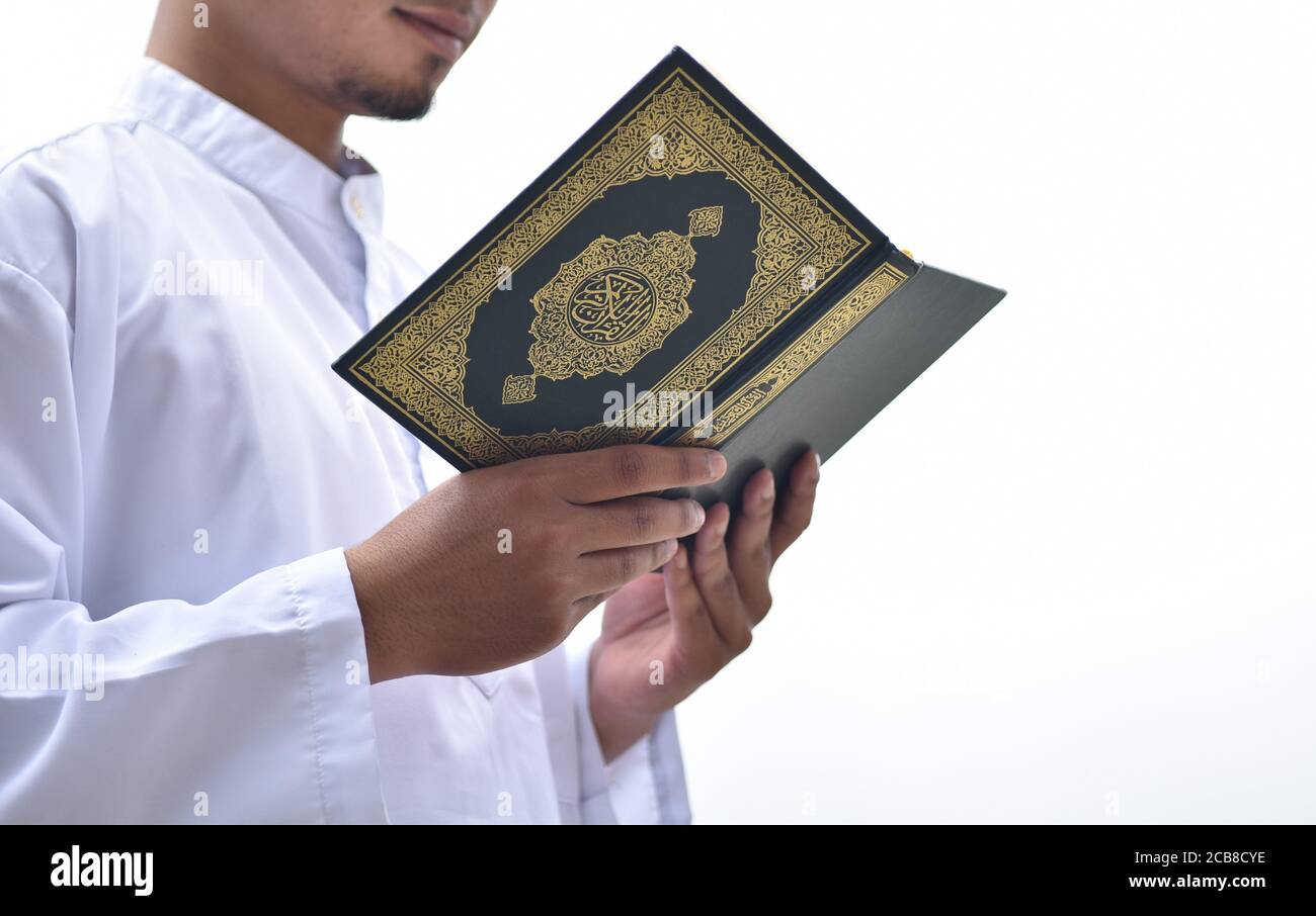 Holy Quran in hand with arabic calligraphy meaning of Al Quran Stock ...