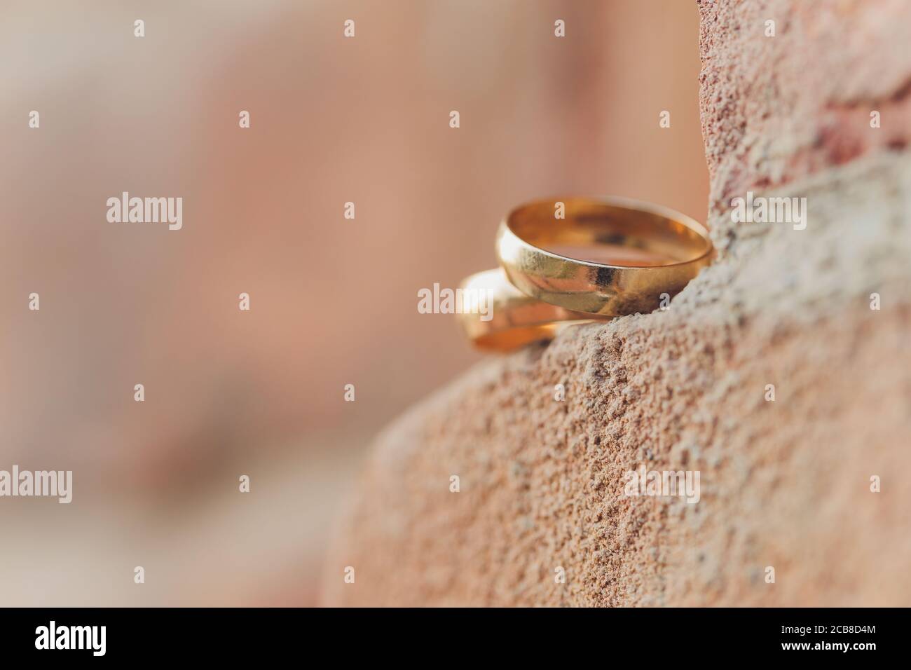 Golden rings on the stones. Two golden wedding rings. The texture of ...