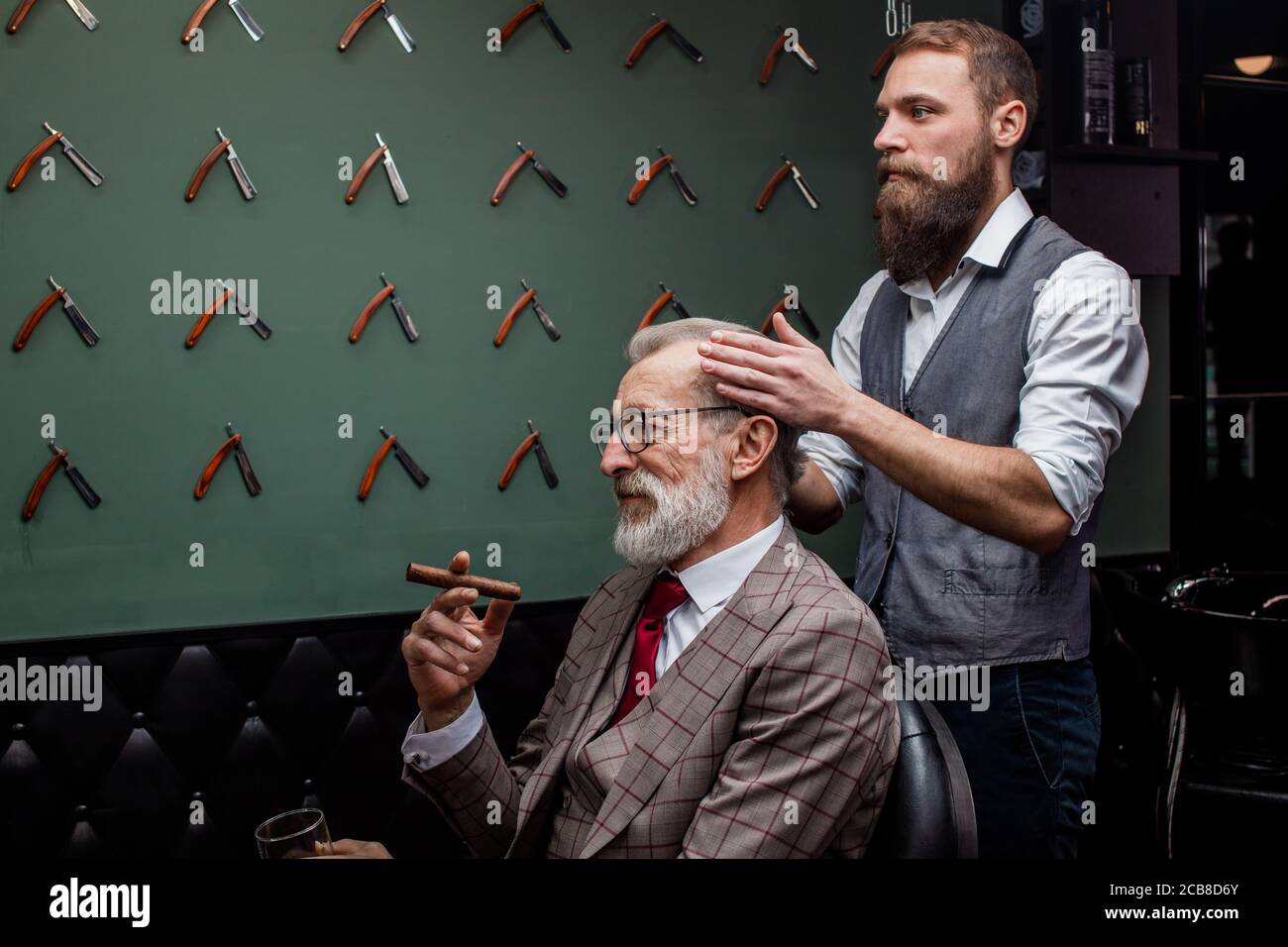 Senior man visiting hairstylist in barber shop. Talanted Haircutter ...