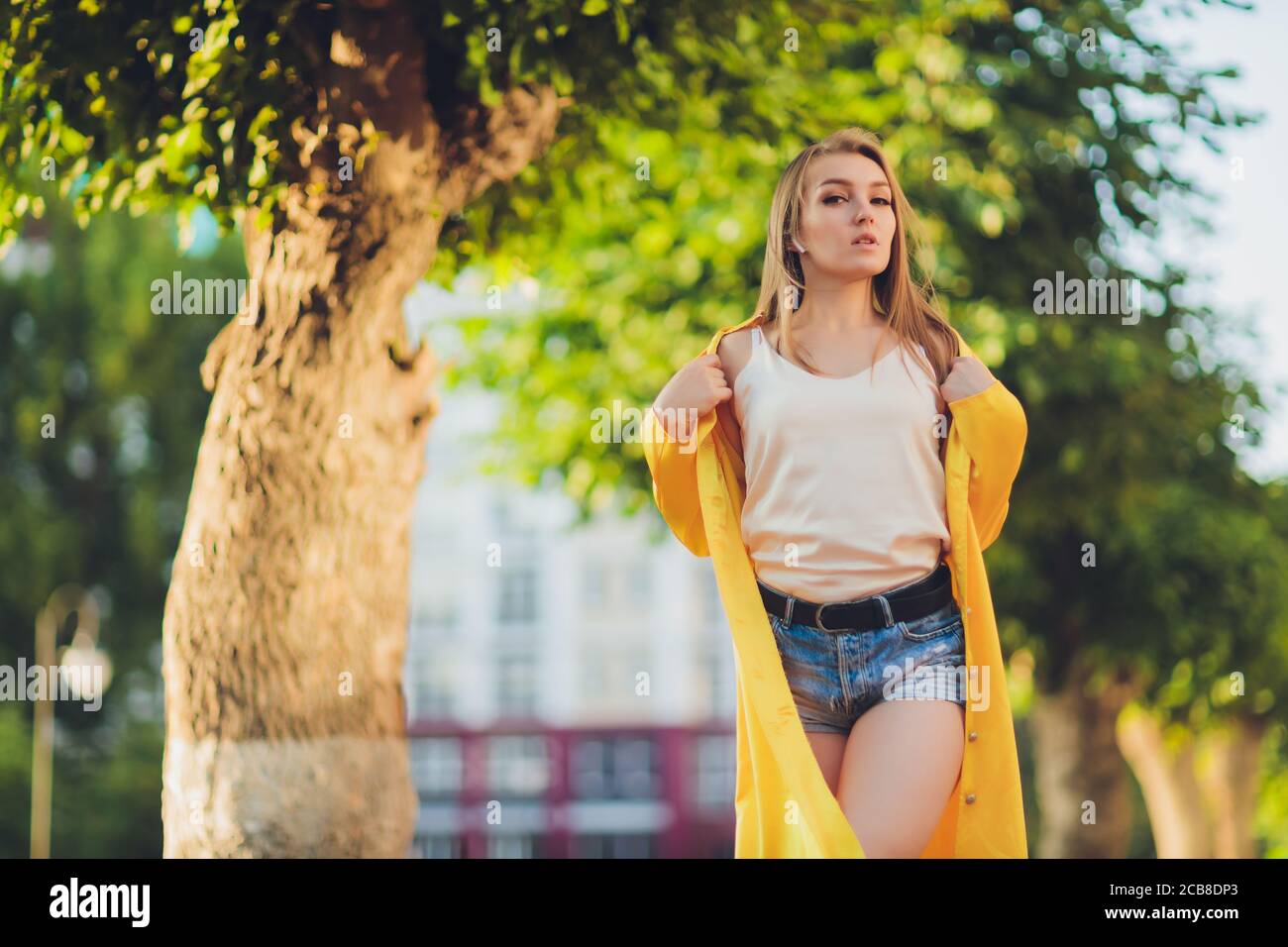 Displaying fashion tendencies. Dark-haired attractive woman posturing ...