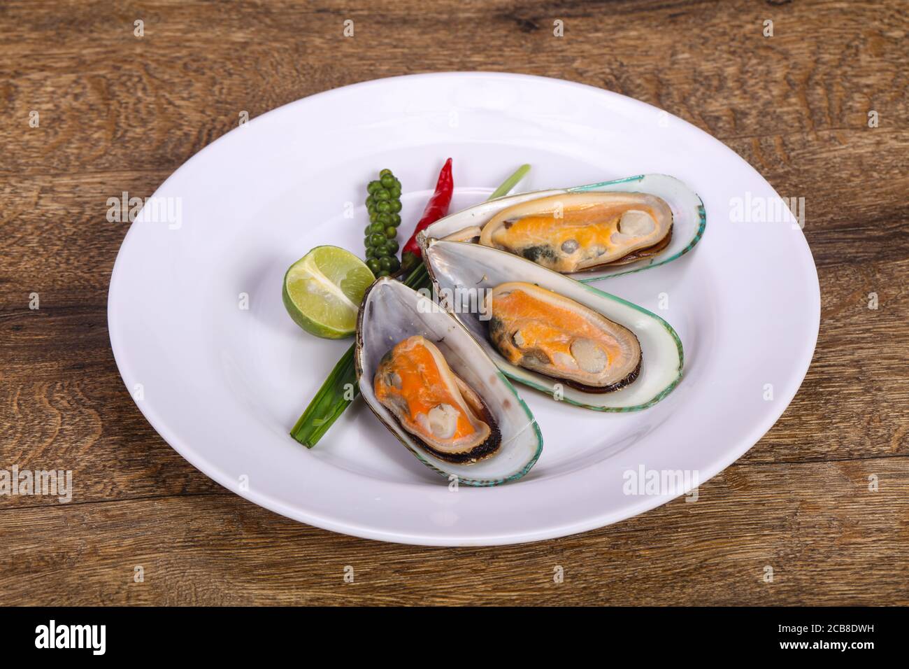 Half mussels with lime and green pepper Stock Photo - Alamy
