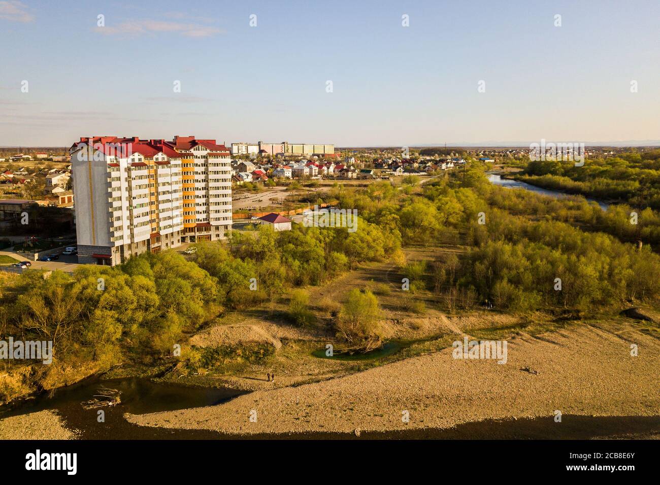 Aerial view of high residential apartment building in green rural area ...