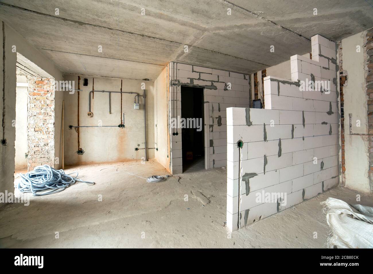 Interior of an apartment room with bare walls and ceiling under ...