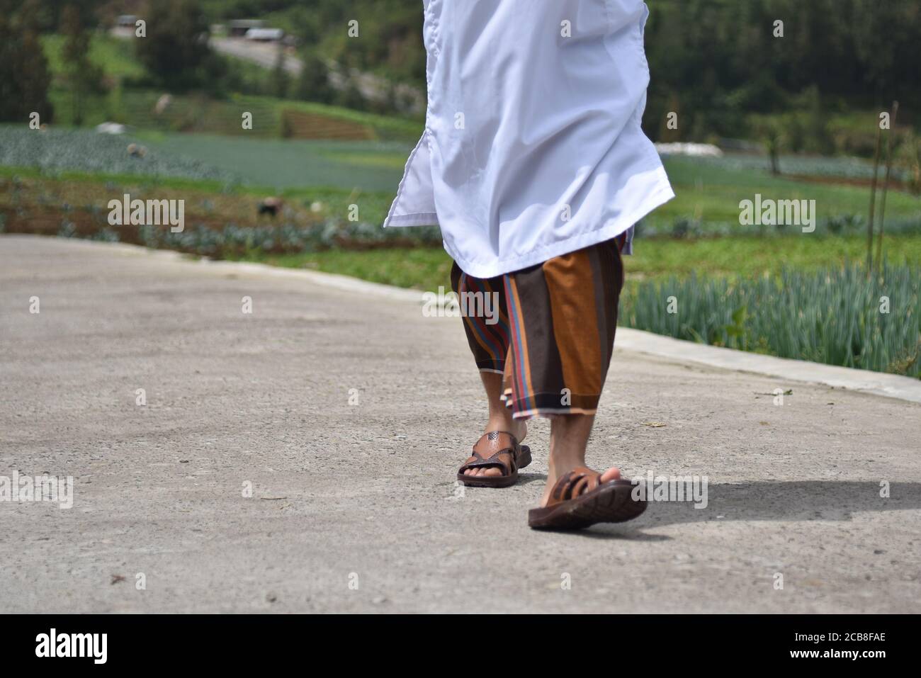 Muslim men wearing sarong are walking Stock Photo - Alamy