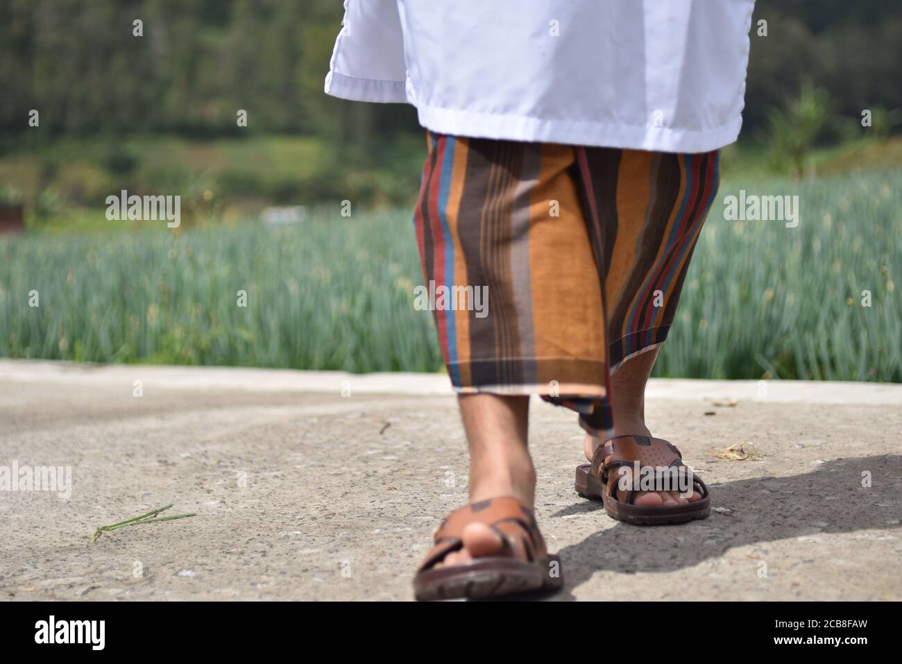 Muslim men wearing sarong are walking Stock Photo - Alamy