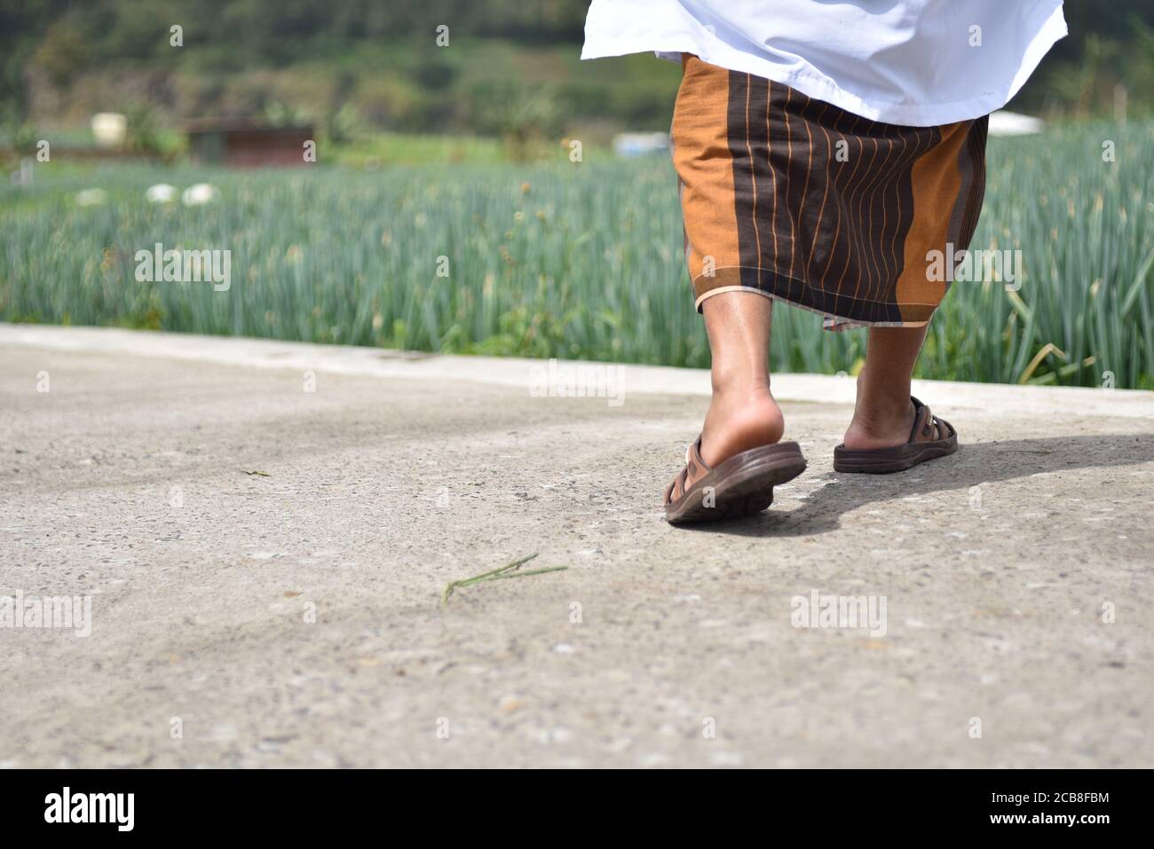 Muslim men wearing sarong are walking Stock Photo - Alamy