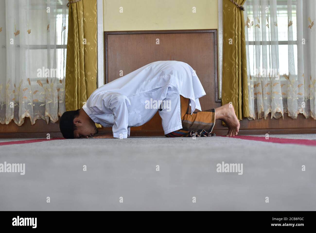 Muslim men praying in sujud / prostration posture Stock Photo - Alamy
