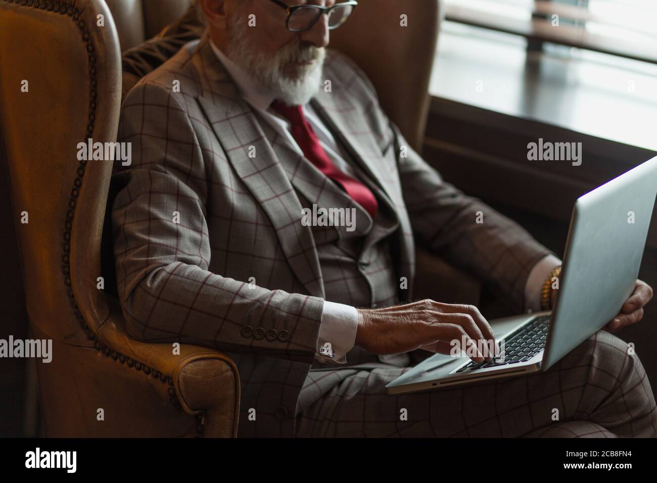 Fashionable focused elderly male writer wearing glasses and elegant ...