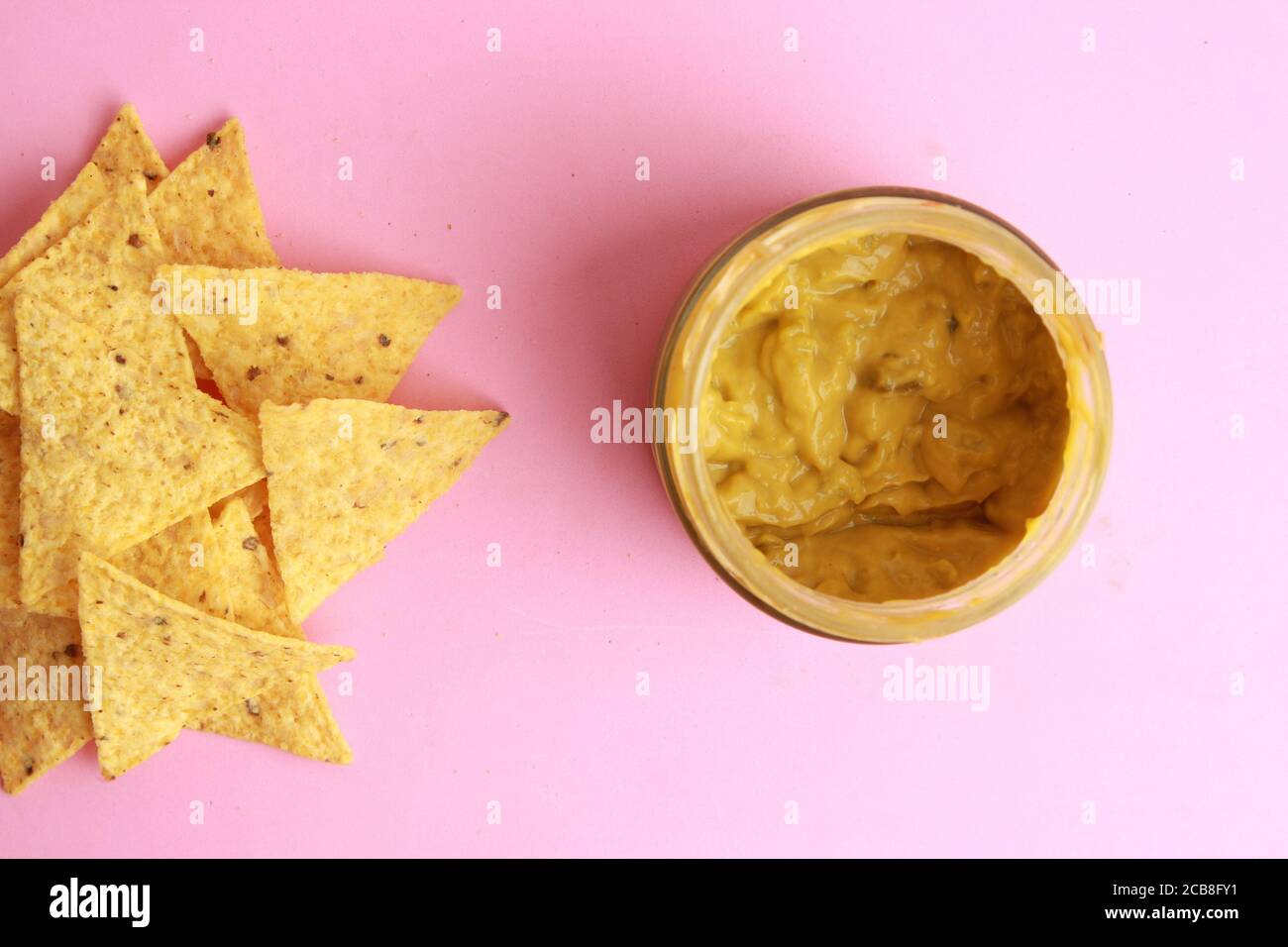 High angle closeup shot of Mexican nachos with guacamole sauce on a ...