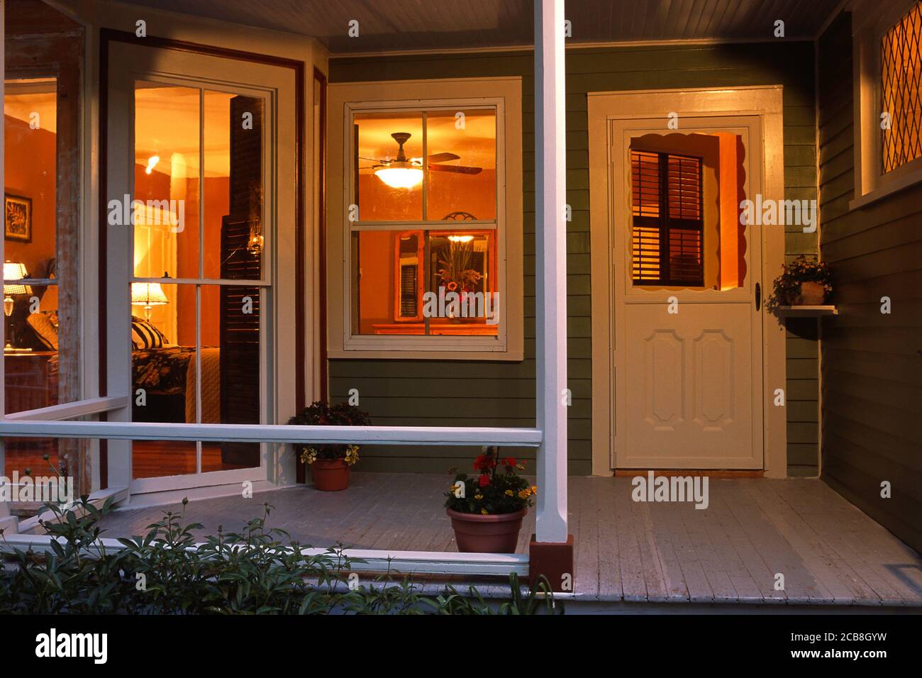Residential home at night with lit windows, USA Stock Photo - Alamy