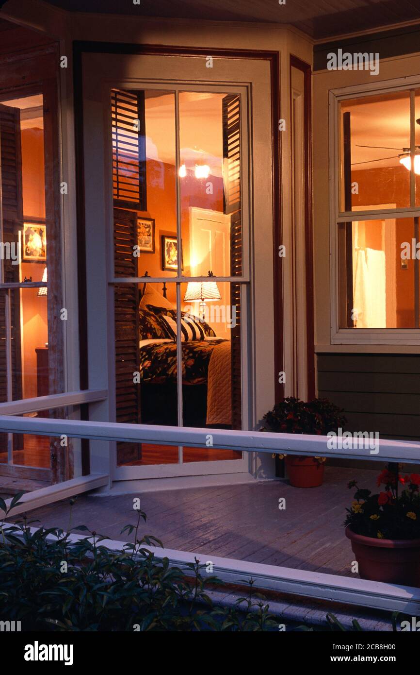 Residential home at night with lit windows, USA Stock Photo - Alamy