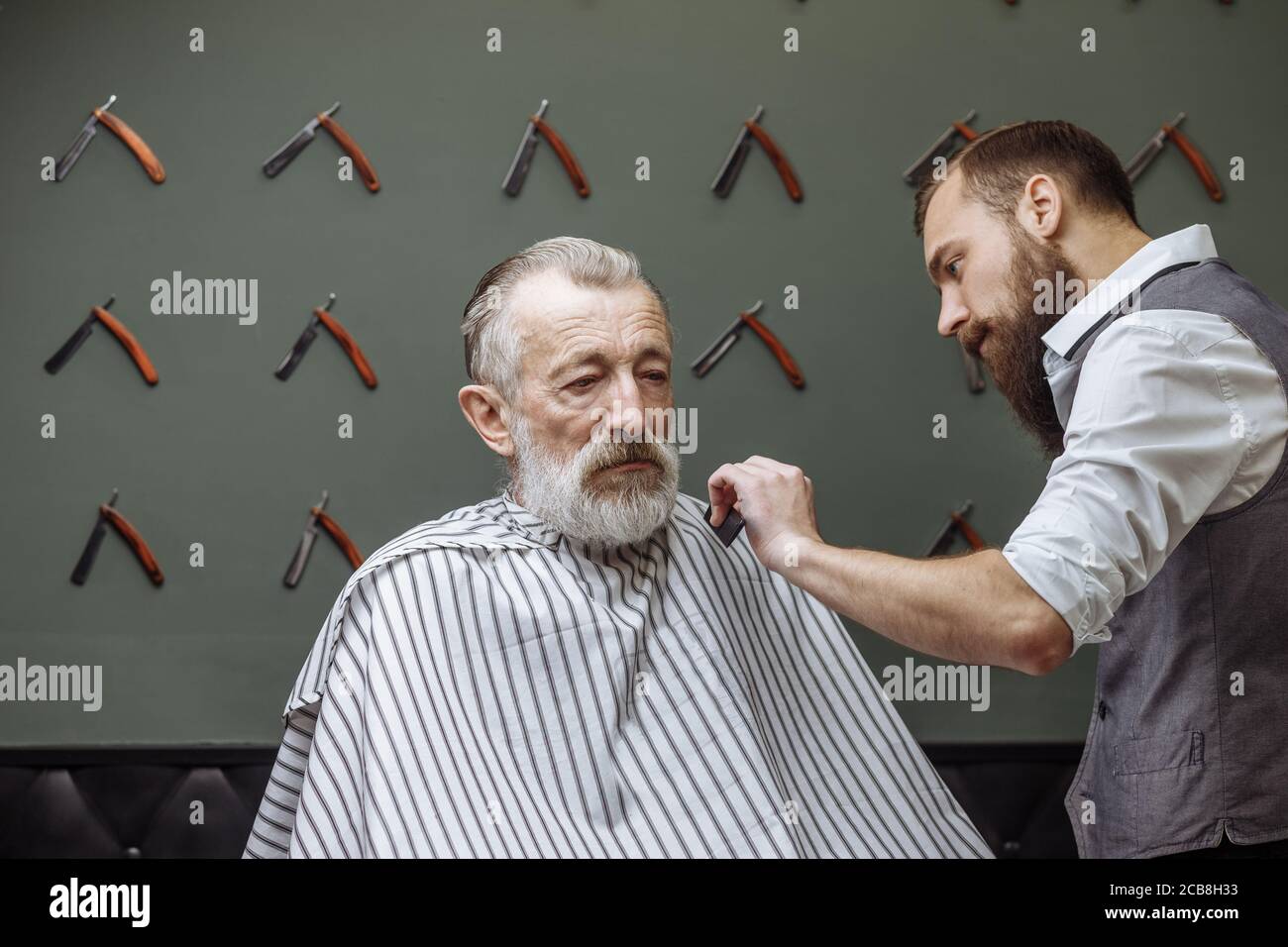 Senior man visiting hairstylist in barber shop. Talanted Haircutter ...