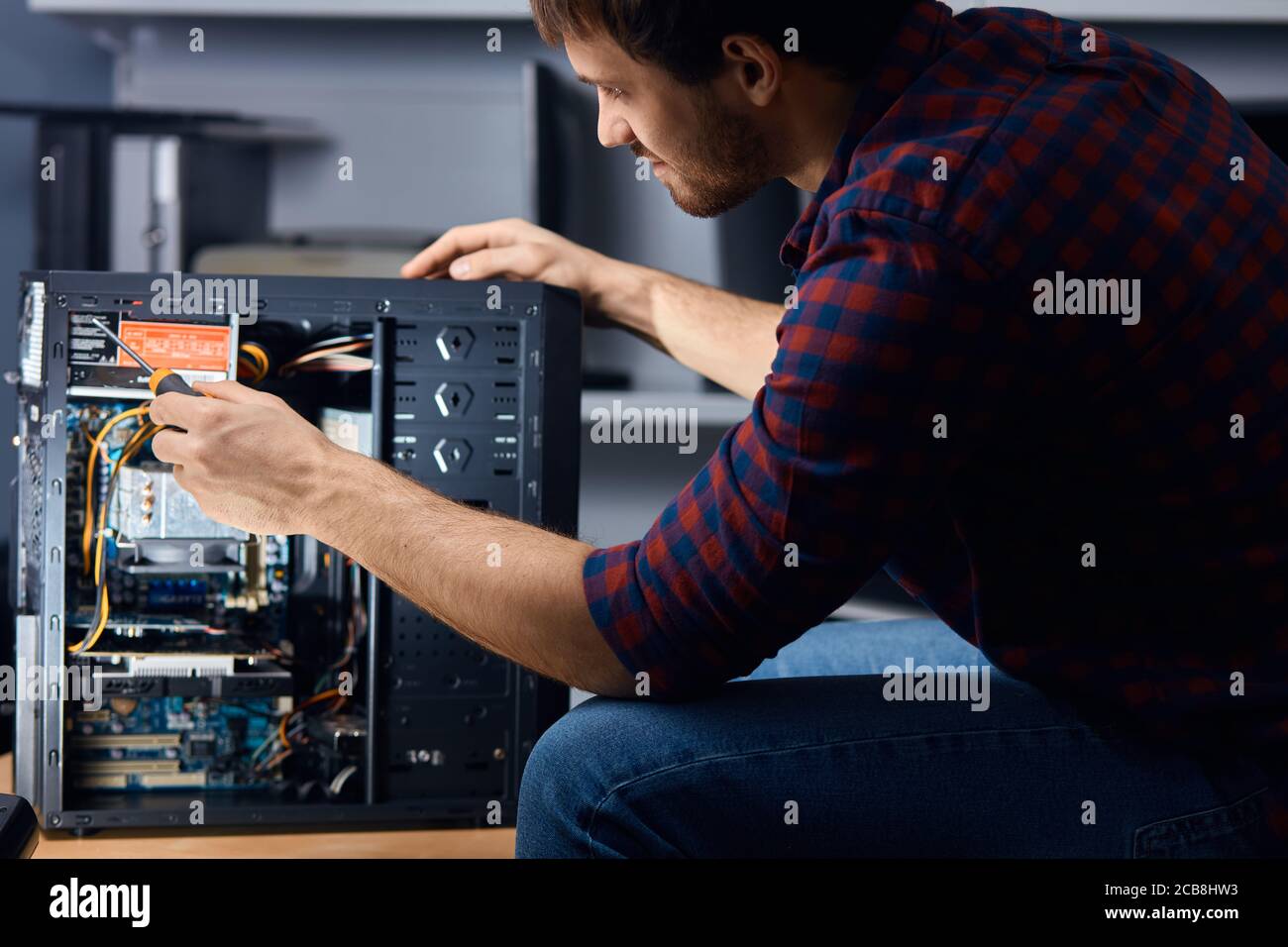 man disassembling and reassembling the computer, close up side view ...