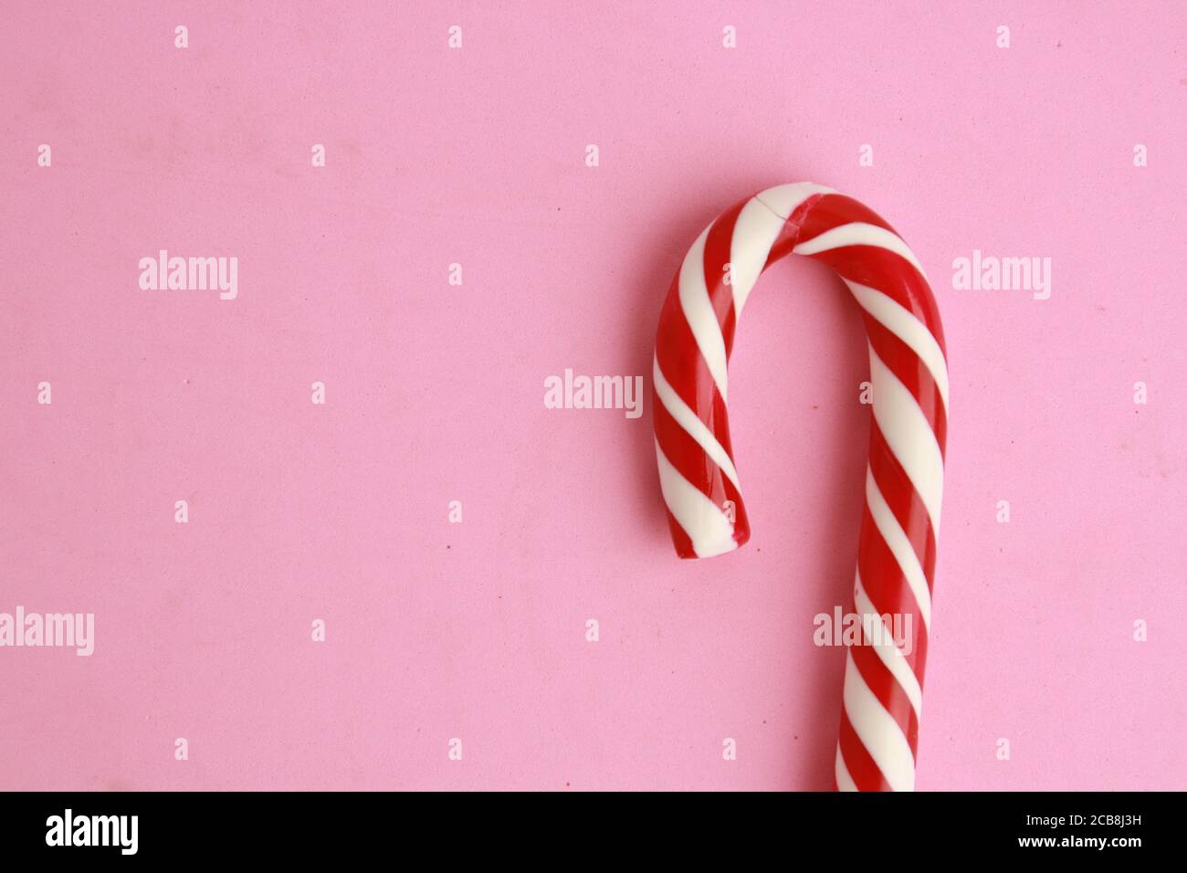 High angle shot of a delicious candy stick isolated on a pink surface ...