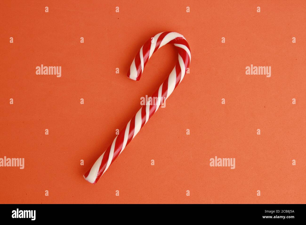 Top view of red candy cane on orange background Stock Photo - Alamy