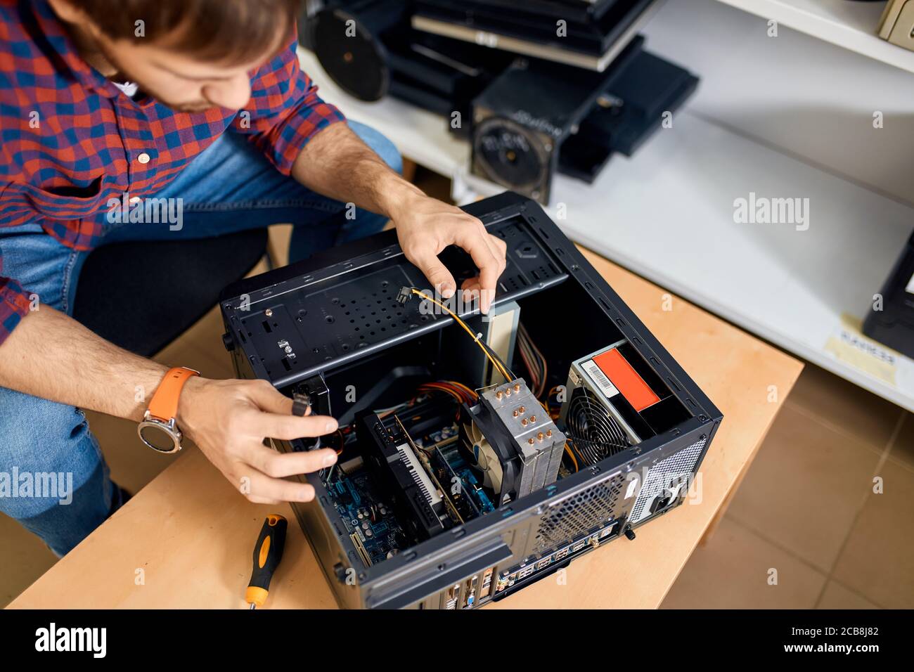 man connecting the wires of system unit. low andle view. cropped photo ...