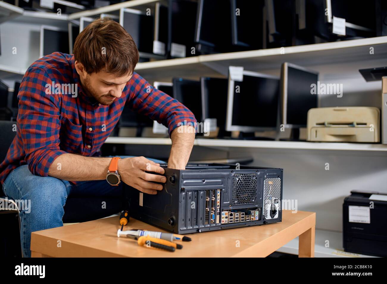 awesome talented man repairing system unit at workplace. close up photo ...