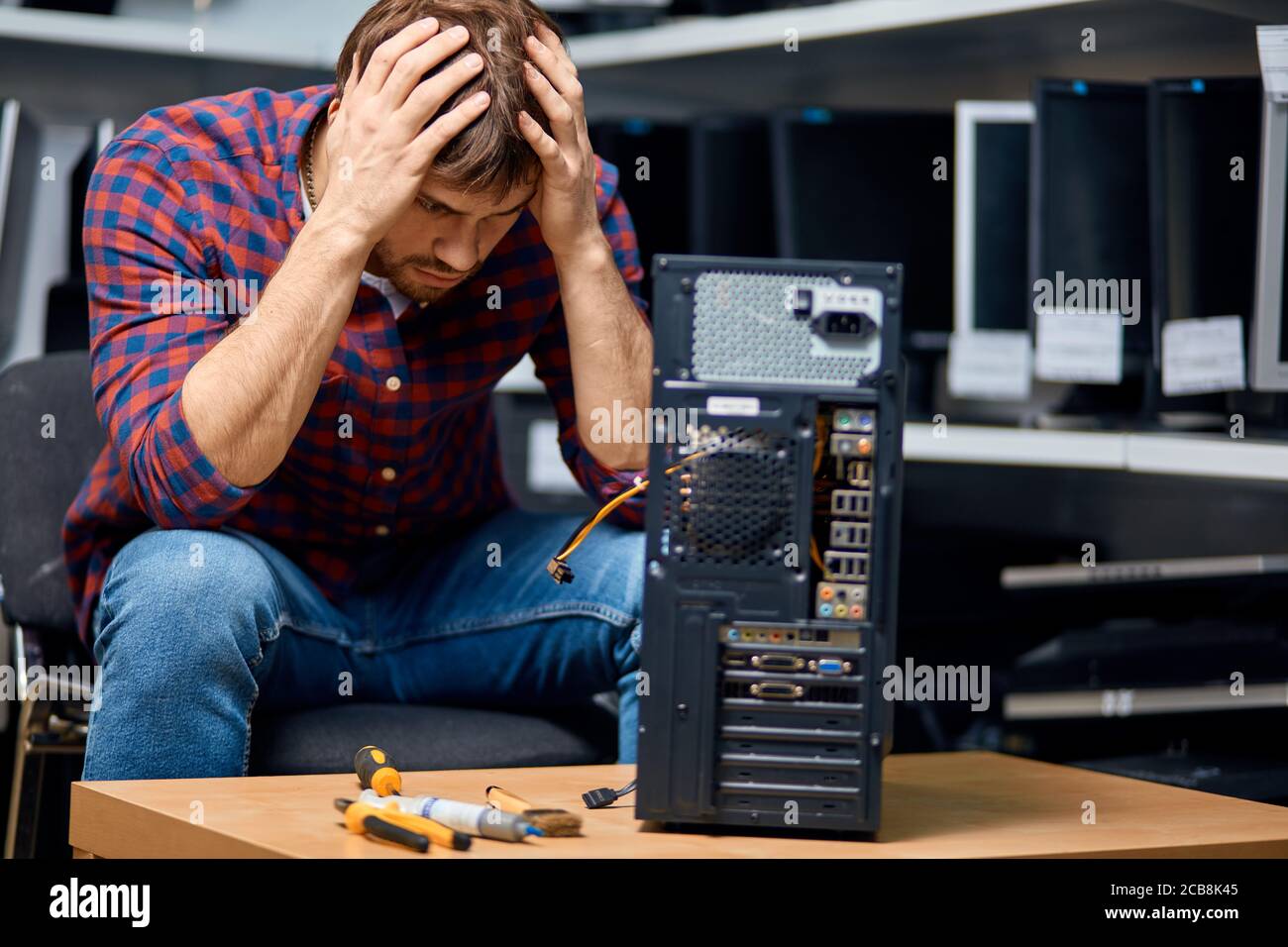 unhappy sad man with hands on his head has broken a computer, bad ...
