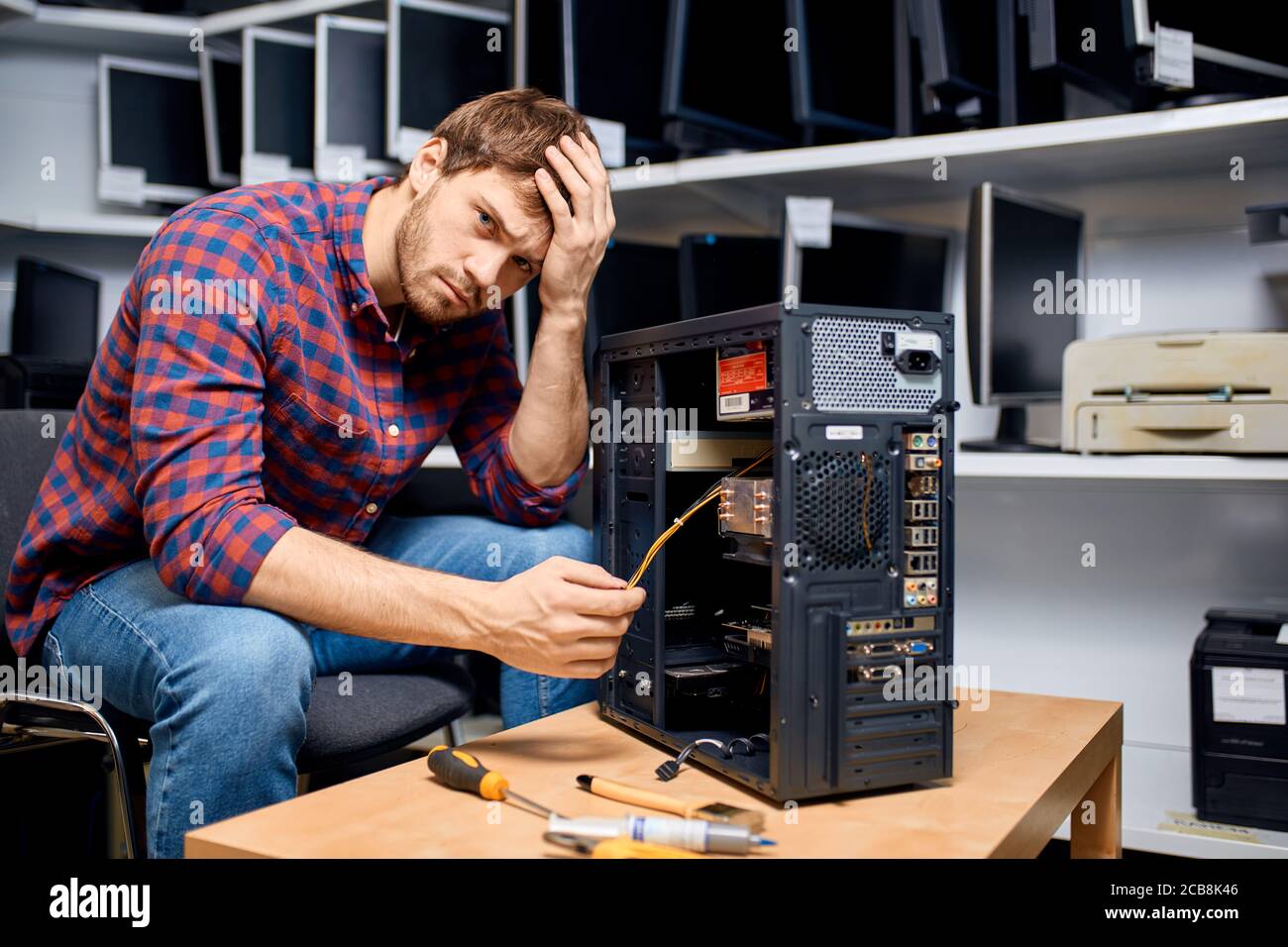 puzzled handsome man cannot solve the computer problem, close up photo ...