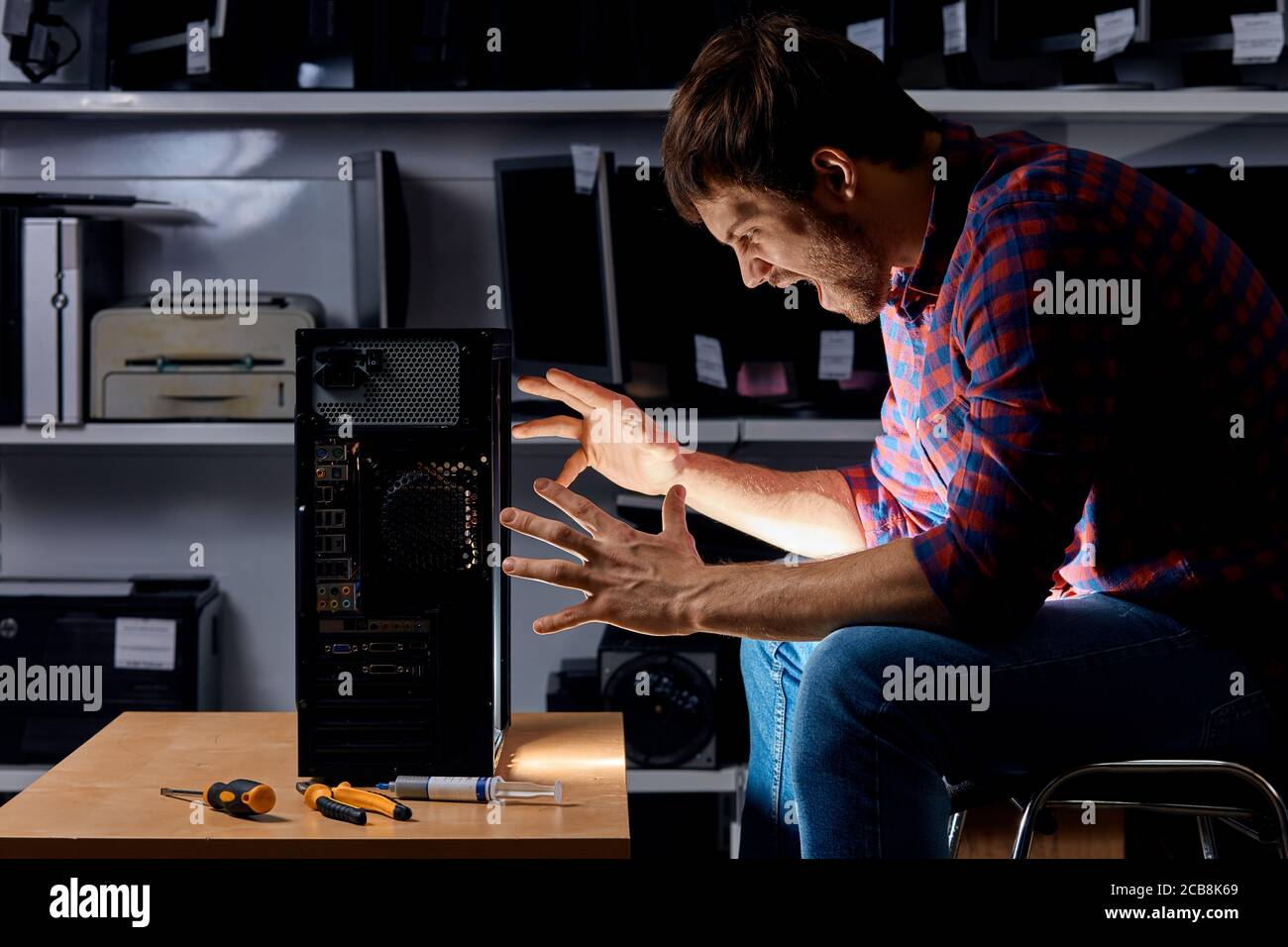 angry man shouting at the system unit, close up side view photo ...