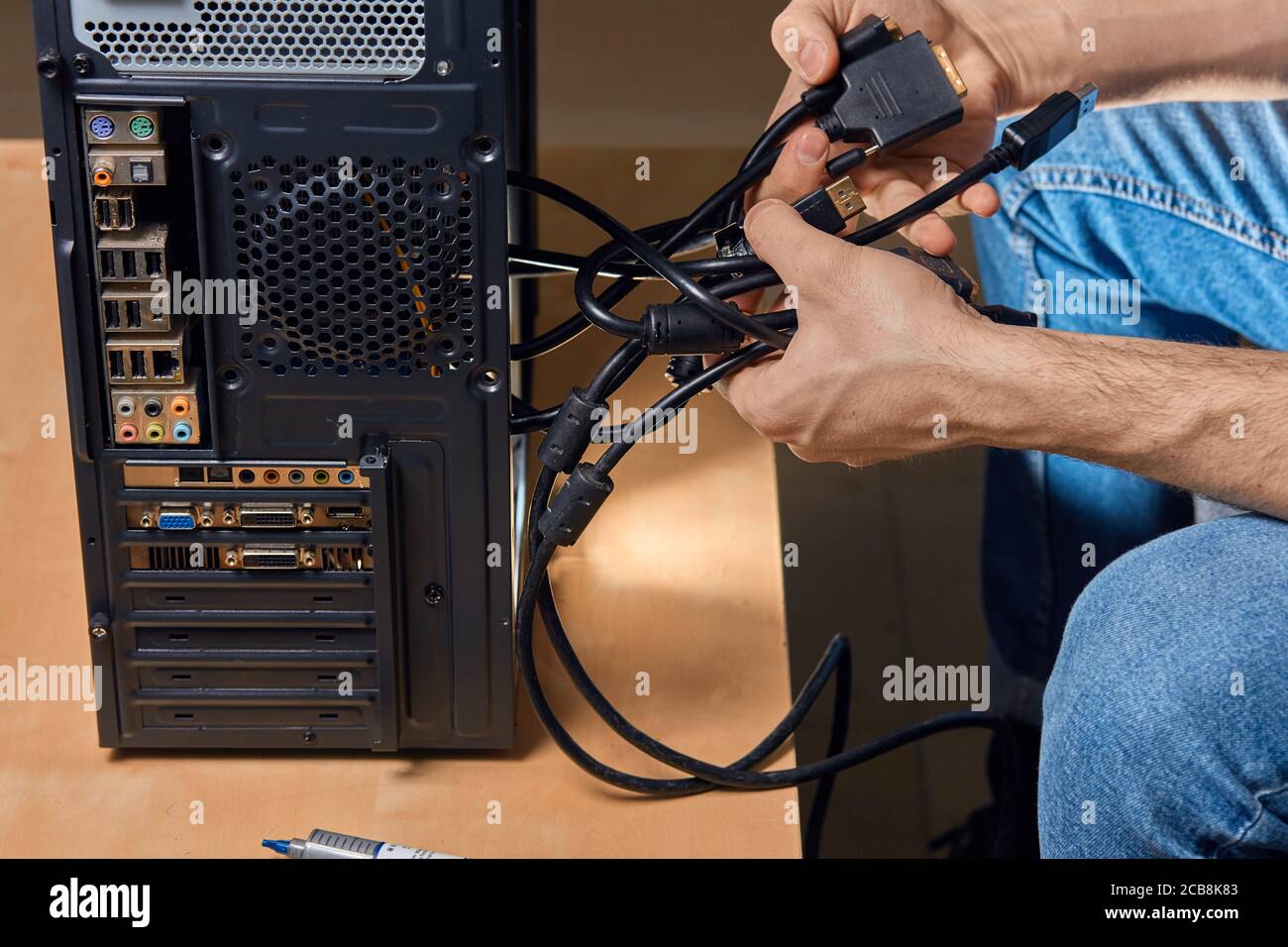 man holding fixed wires,guy trying to untangle the wires . close up ...