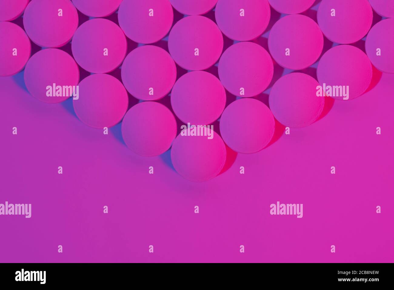 Geometrc triangle pattern of round medical pills on background with ...