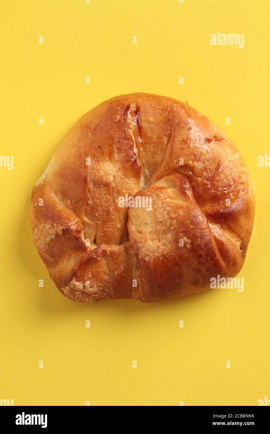 Vertical closeup of fresh-baked bread on a yellow surface Stock Photo ...