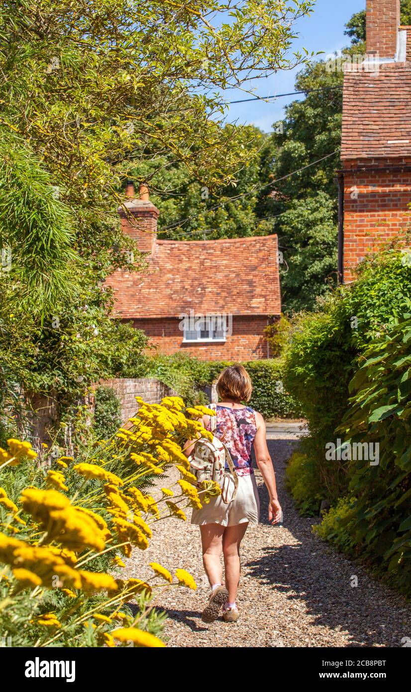 Woman walking through the Oxfordshire Chilterns village of Ewelme Stock ...