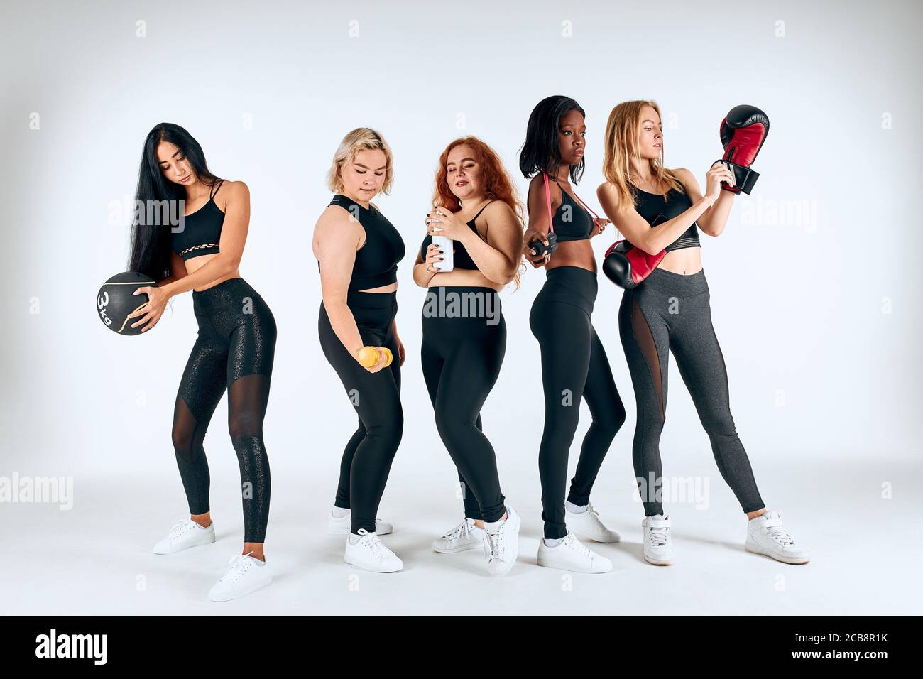 Young different girls doing sport exercises isolated over white ...