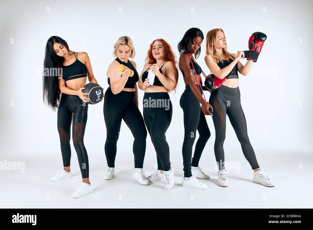 Young different girls doing sport exercises isolated over white ...