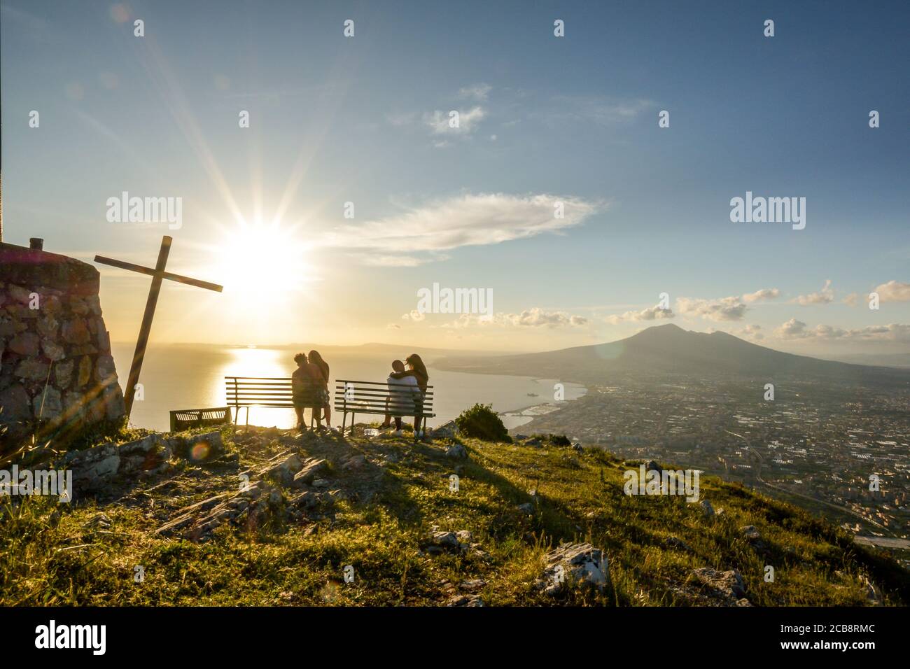 Amazing landscape with two lovely couples hugging with sunset in front ...