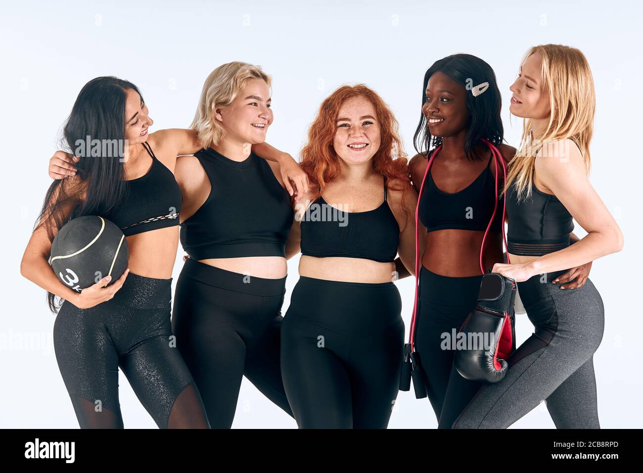 Portrait of multi-ethnic group of slim girls, different size and ...