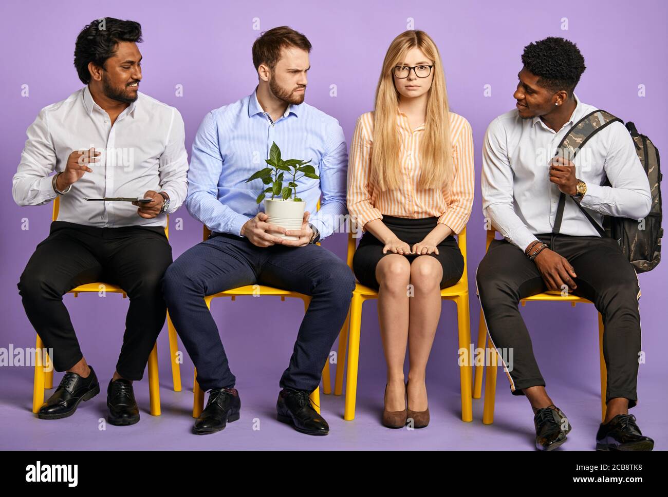 multinational team sitting together and looking at pretty girl in ...
