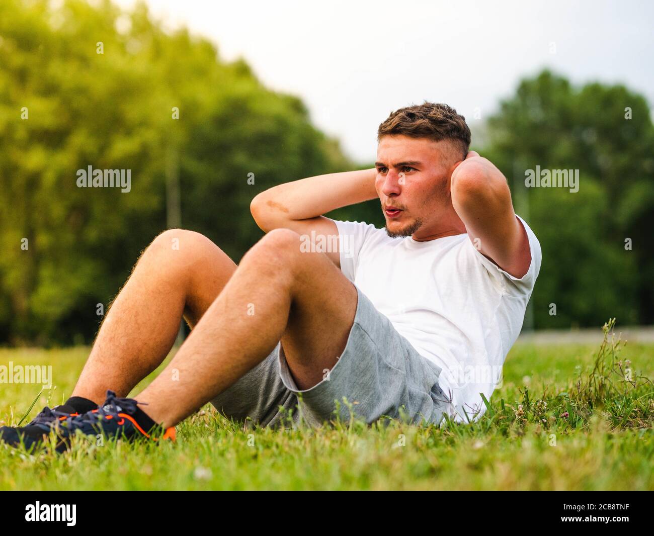 Young attractive sportsman having training outdoors - workout concept ...