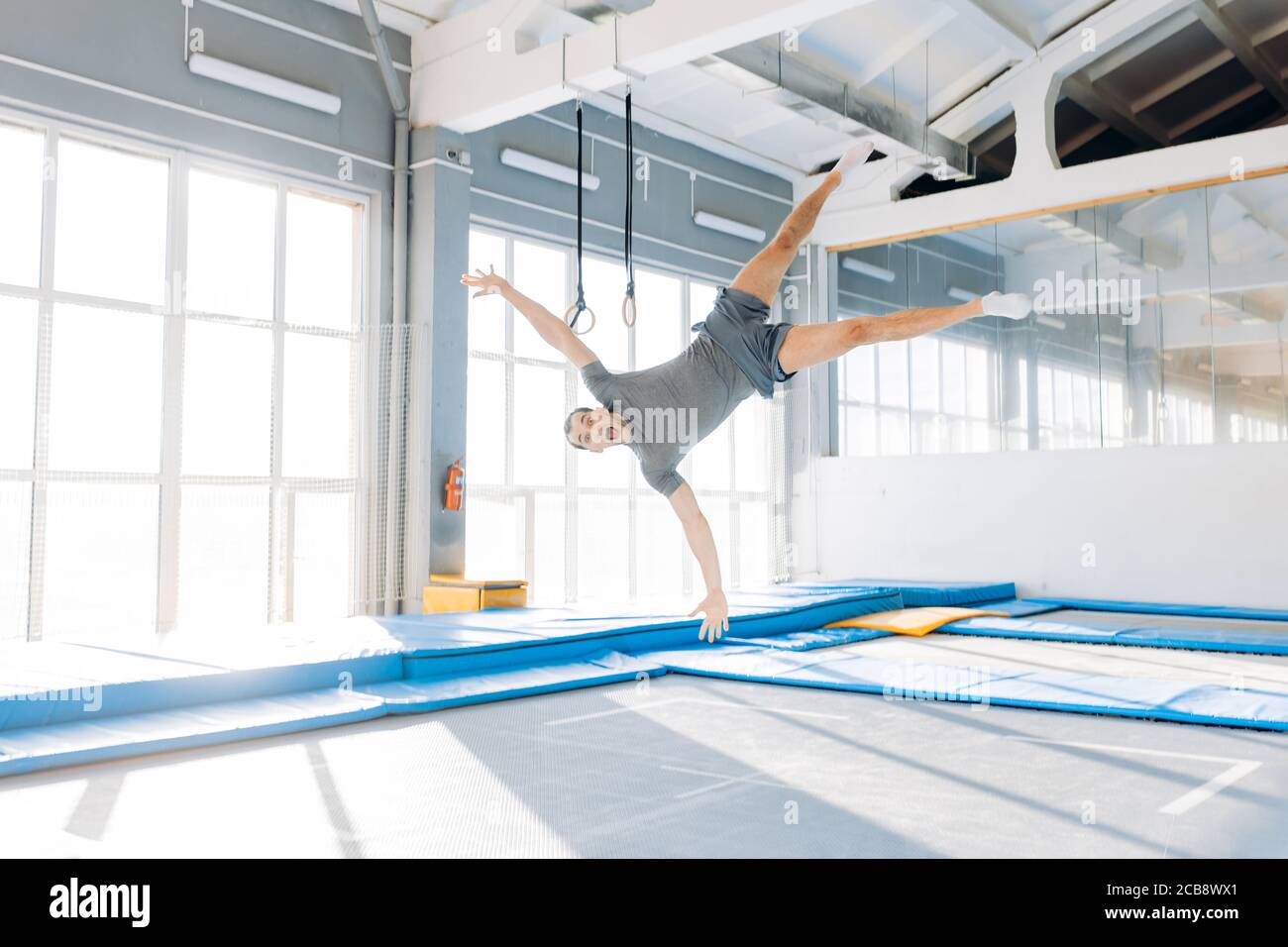 crazy scared man with opened mouth jumping on a trampoline, fear, fobia ...