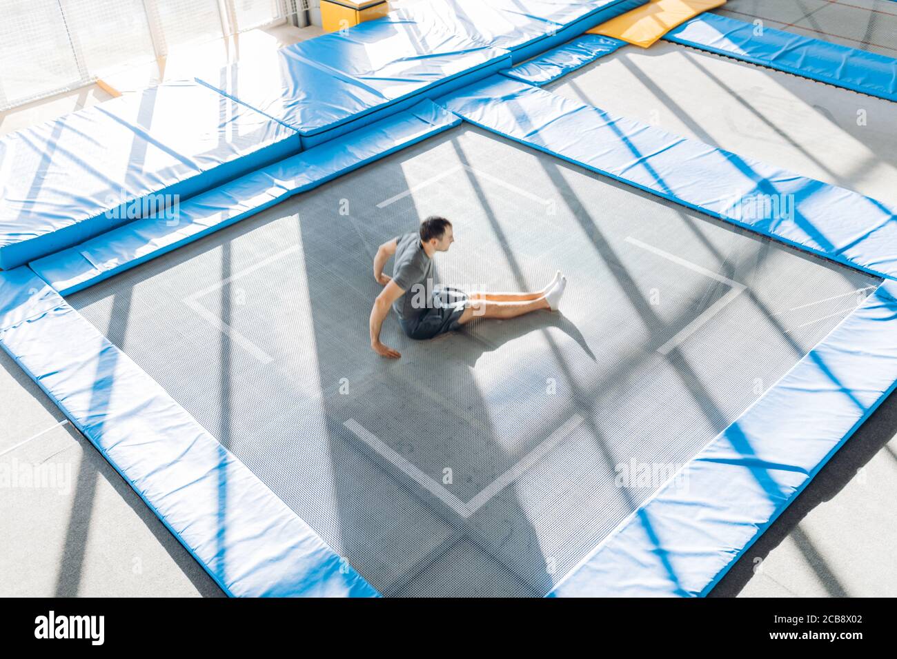 man playing at playground. side view shot. man doing exercises on the ...