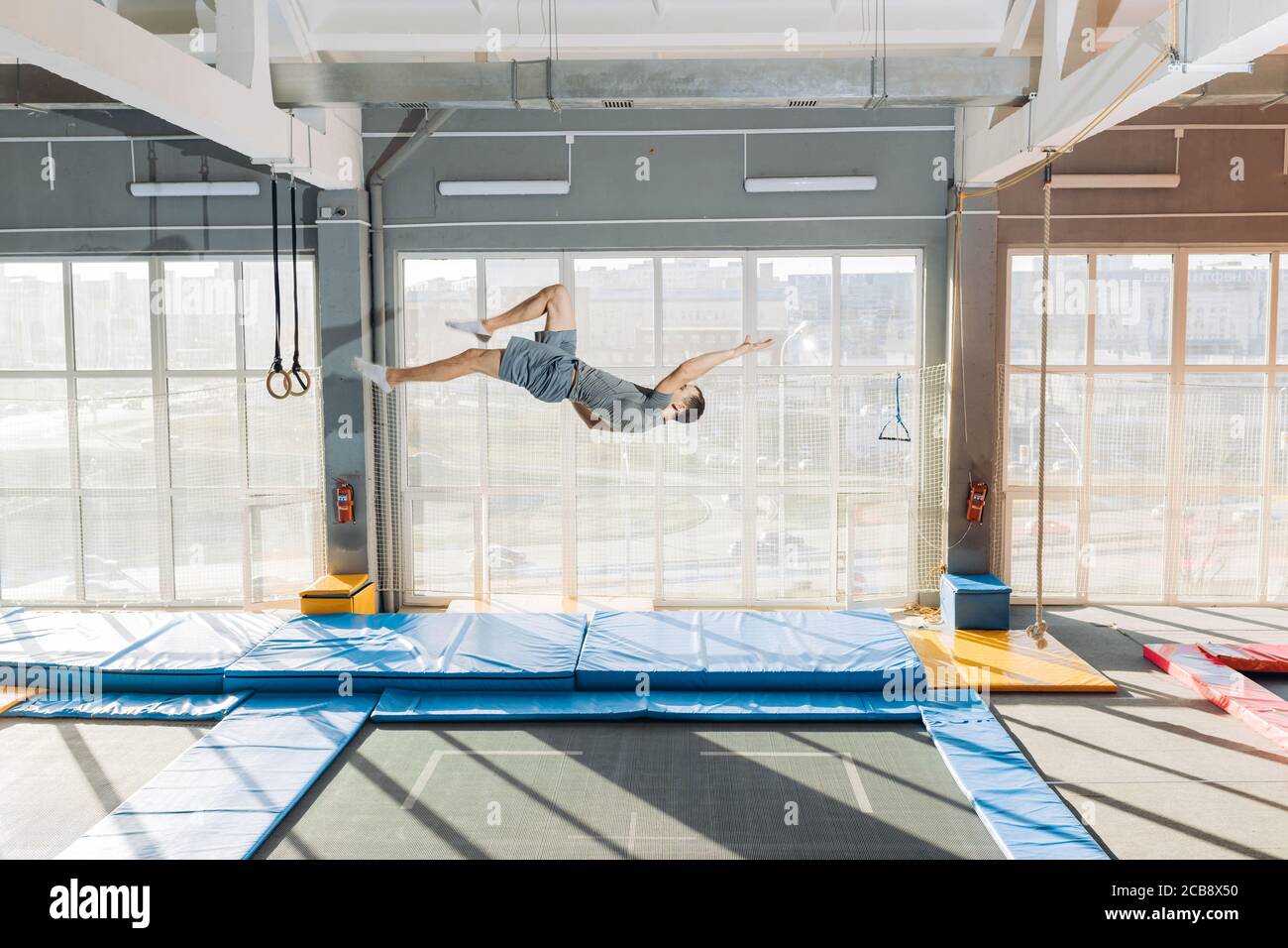 funny posture d turing the jumping on the trampoline. full length side ...