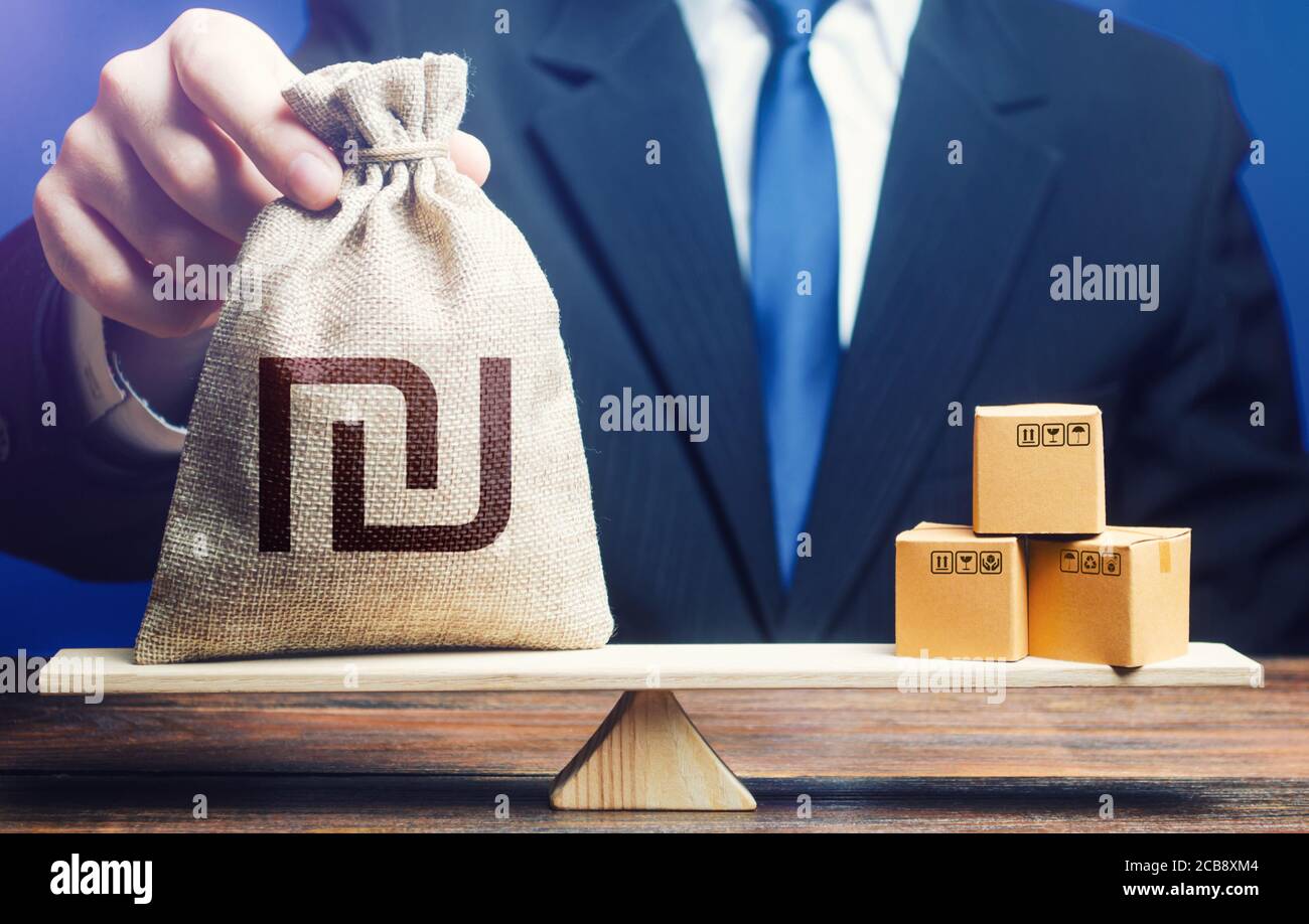Israeli shekel money bag and boxes on scales. Trade balance and ...