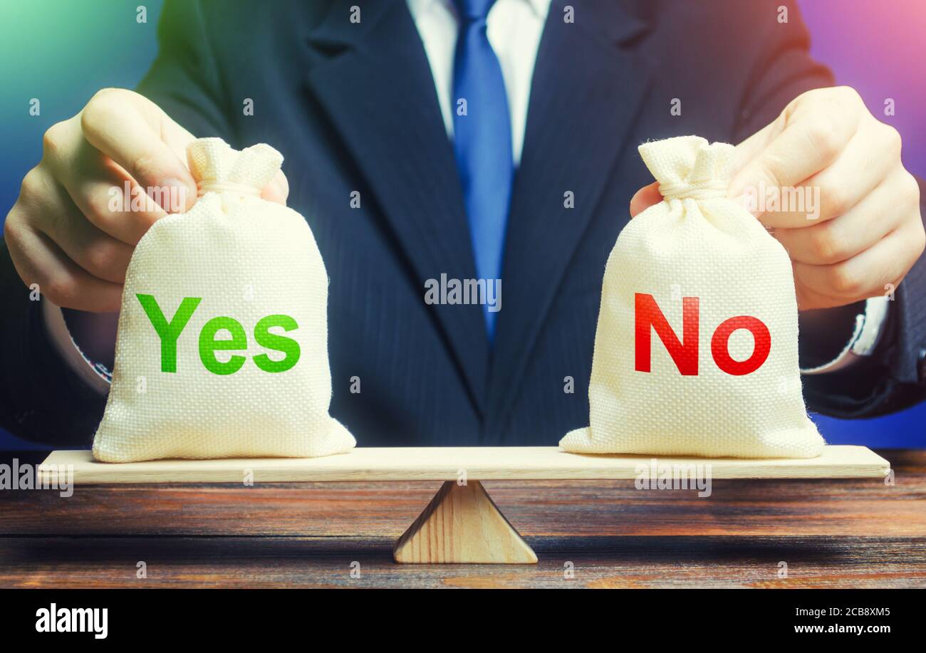 A businessman holds Yes and No bags on scales. Assessing problem and ...