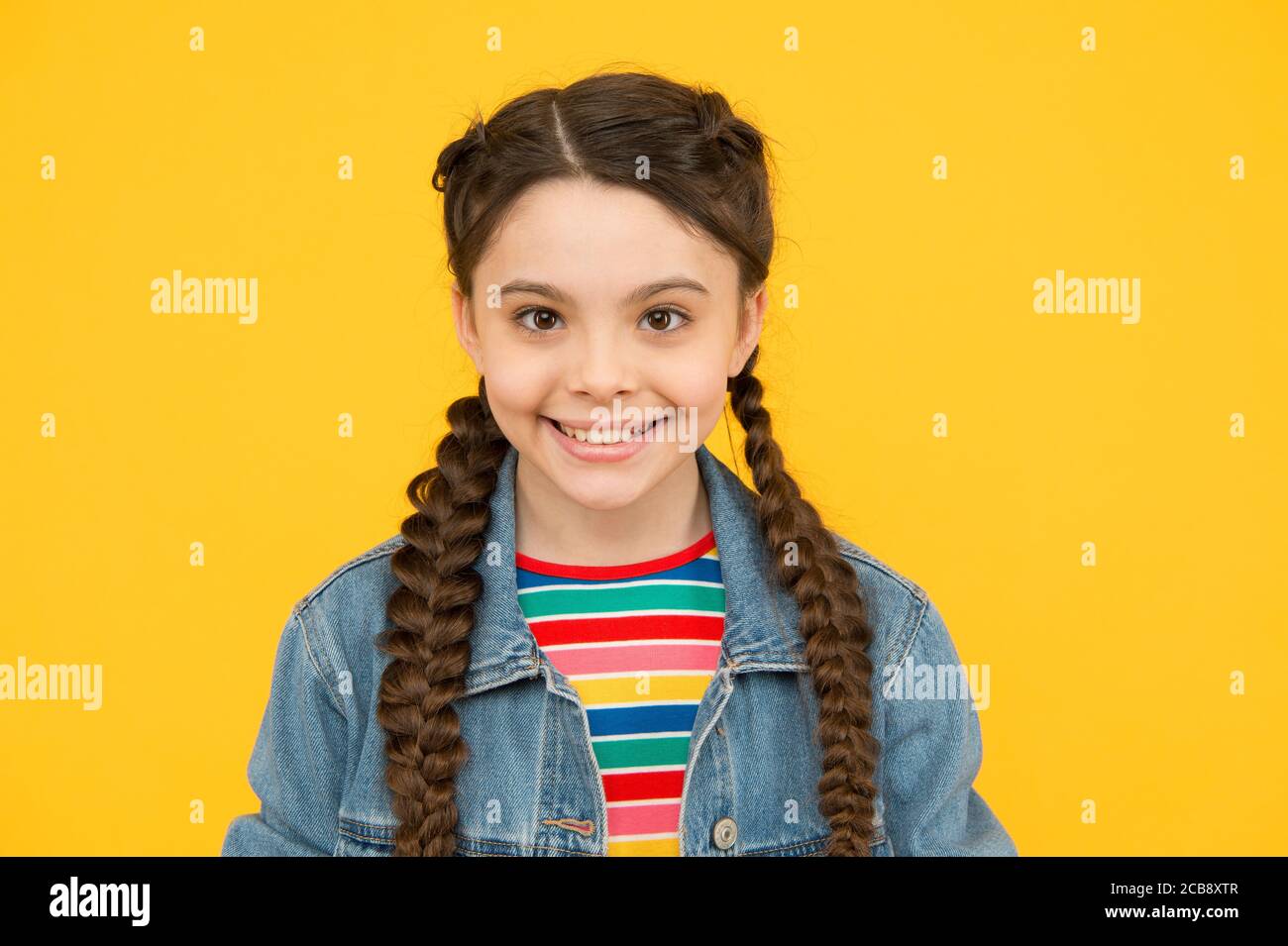 Happy little girl with braids wear denim clothes, fashion trend concept ...