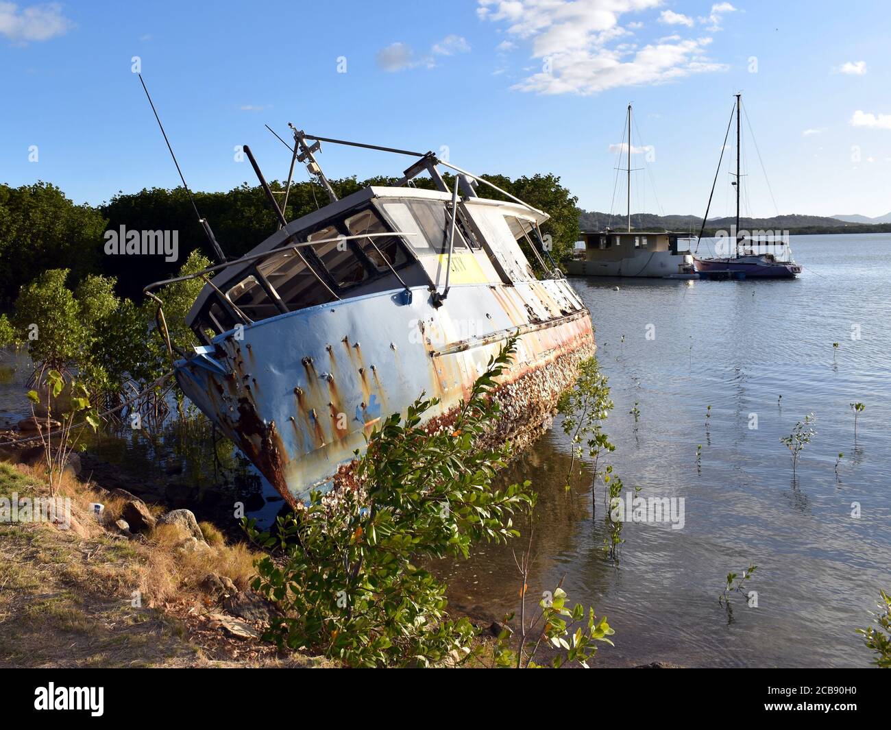 A neglected boat on its side in Mangroves in Far North Queensland Stock ...