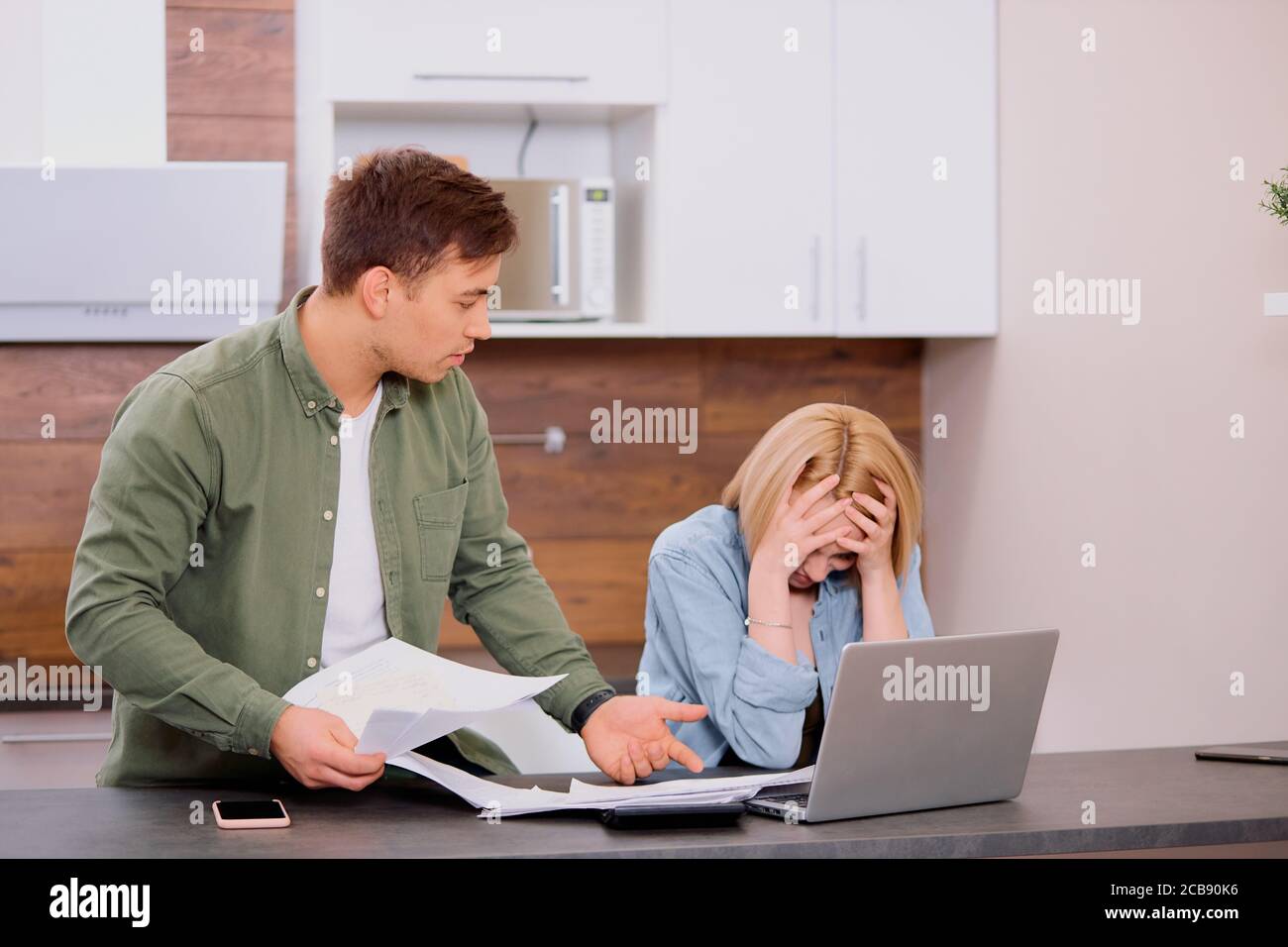 disappointed sad couple upset with finance at home, sitting with laptop ...