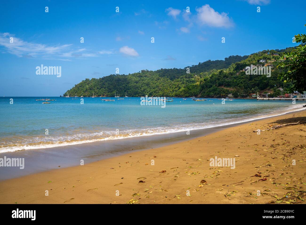Ocean waves hitting the sandy beach and gleaming under the cloudy sky ...