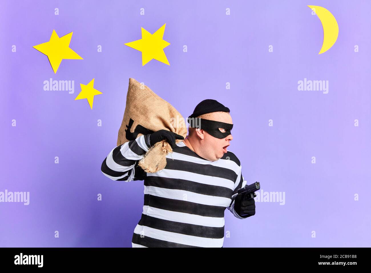 prisoner in striped uniform commiting a crime. close up side view photo ...