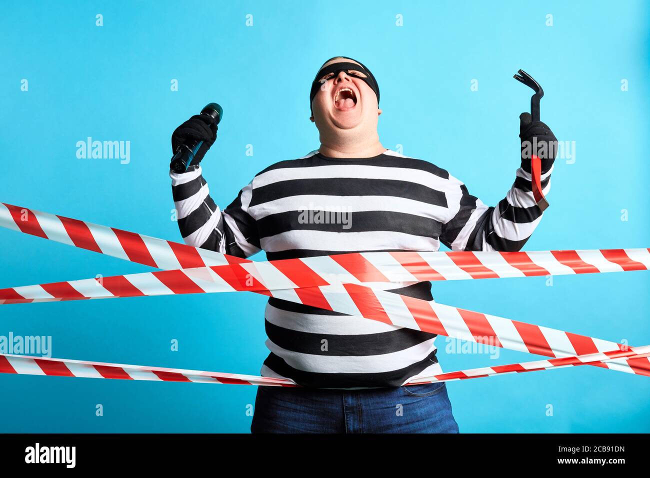 angry nervous mad man looking up, isolated blue background, studio shot ...