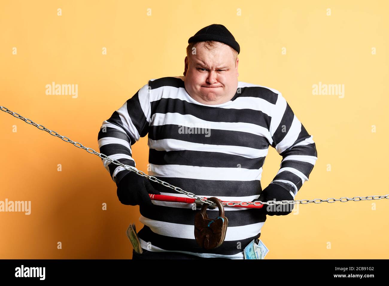 nervous prisoner making effort to cut the chain of the house, close up ...