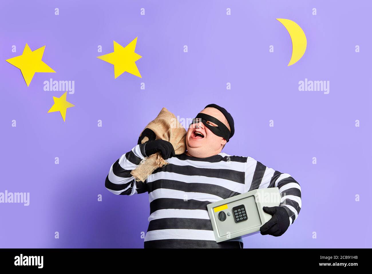 Happy cheerful plump robber carries sack and safe full of dollars ...