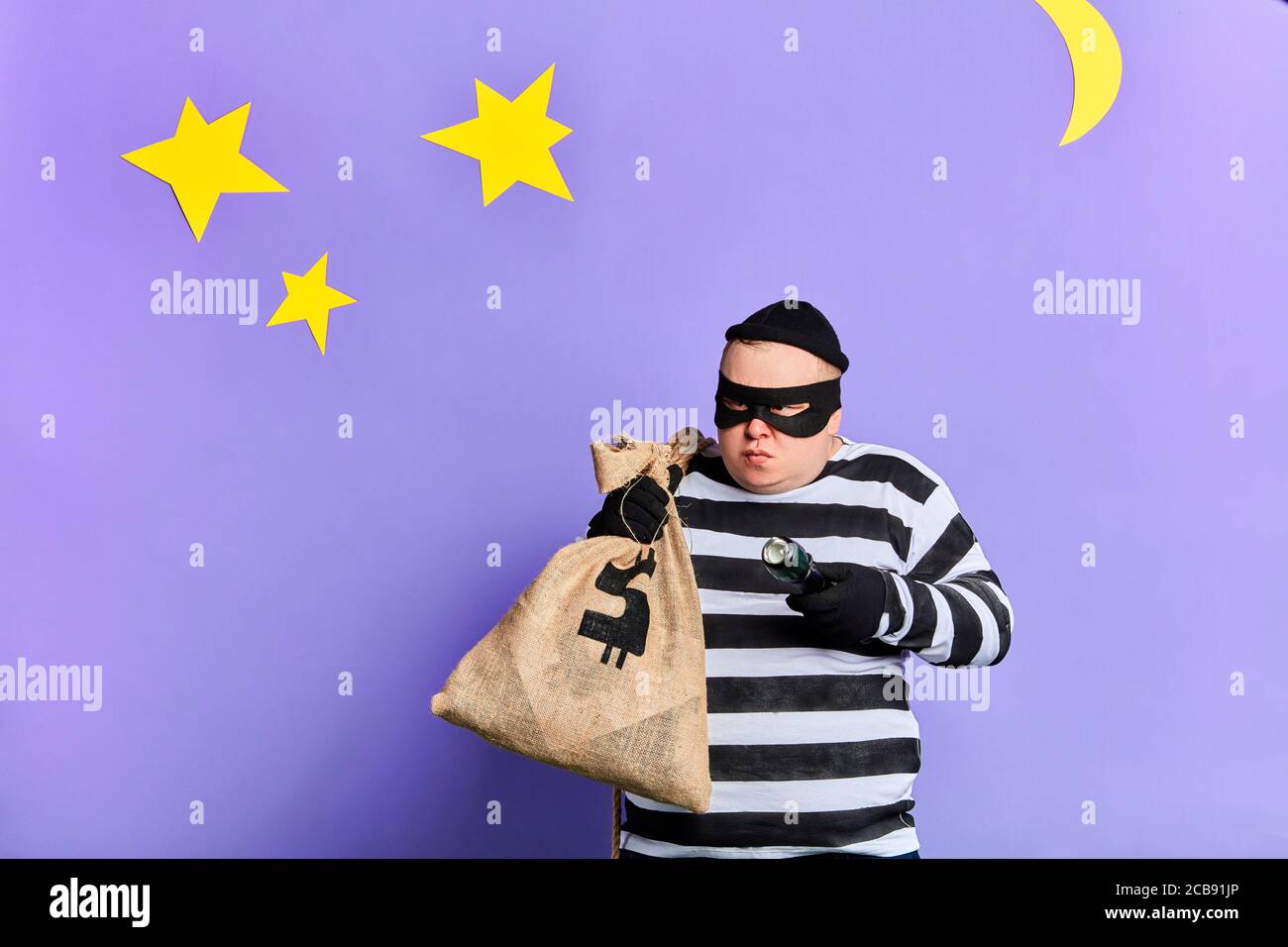 careful prisoner with a sack trying to hide from police. close up ...