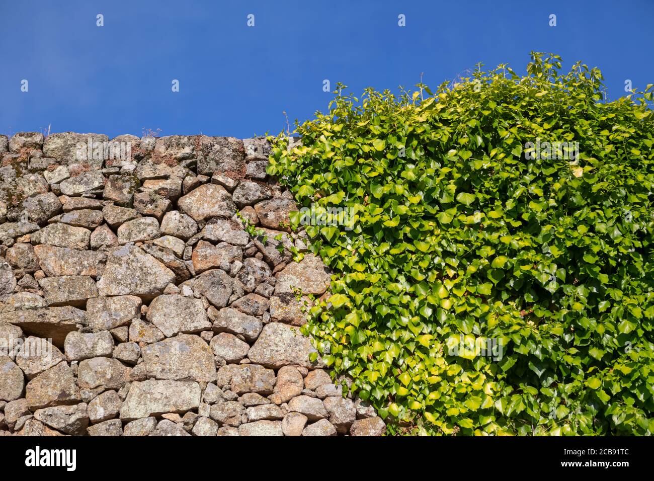 View at the exterior rustic wall in granite stone masonry with ...